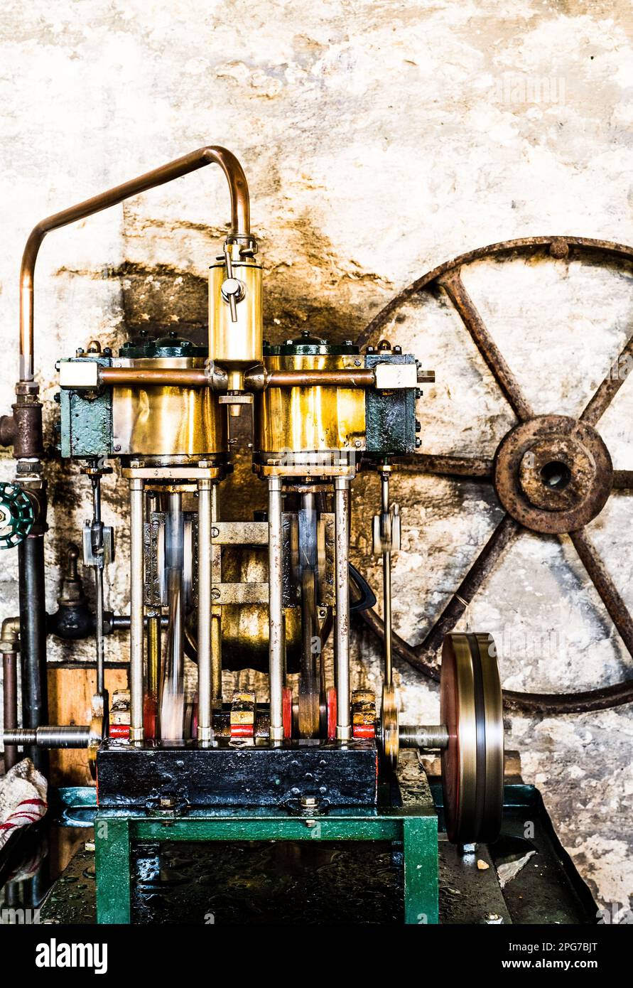 An engine and a set of wheels resting side by side on a flat surface ...