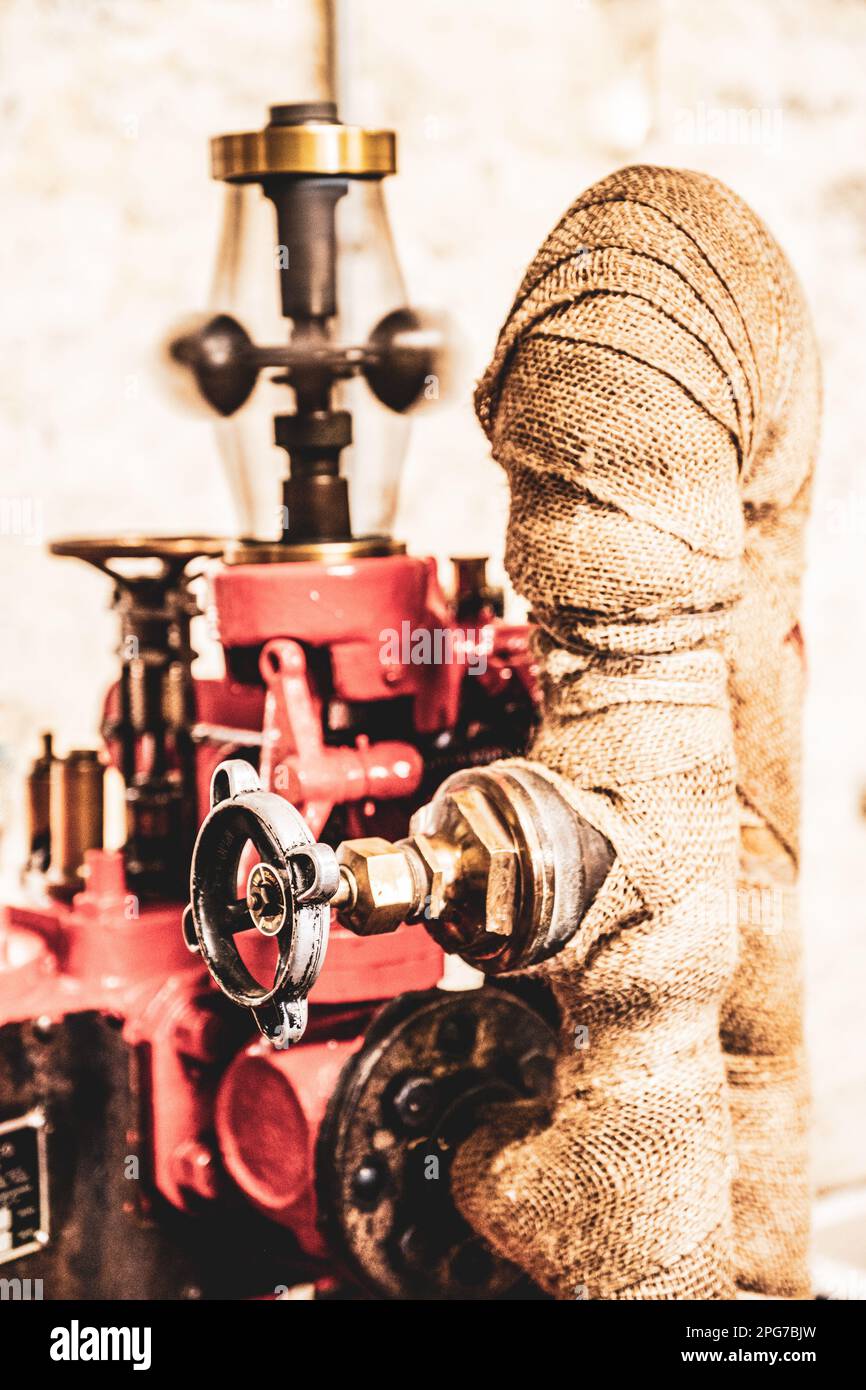 A vintage fire hydrant with a rope tied around the back end Stock Photo ...