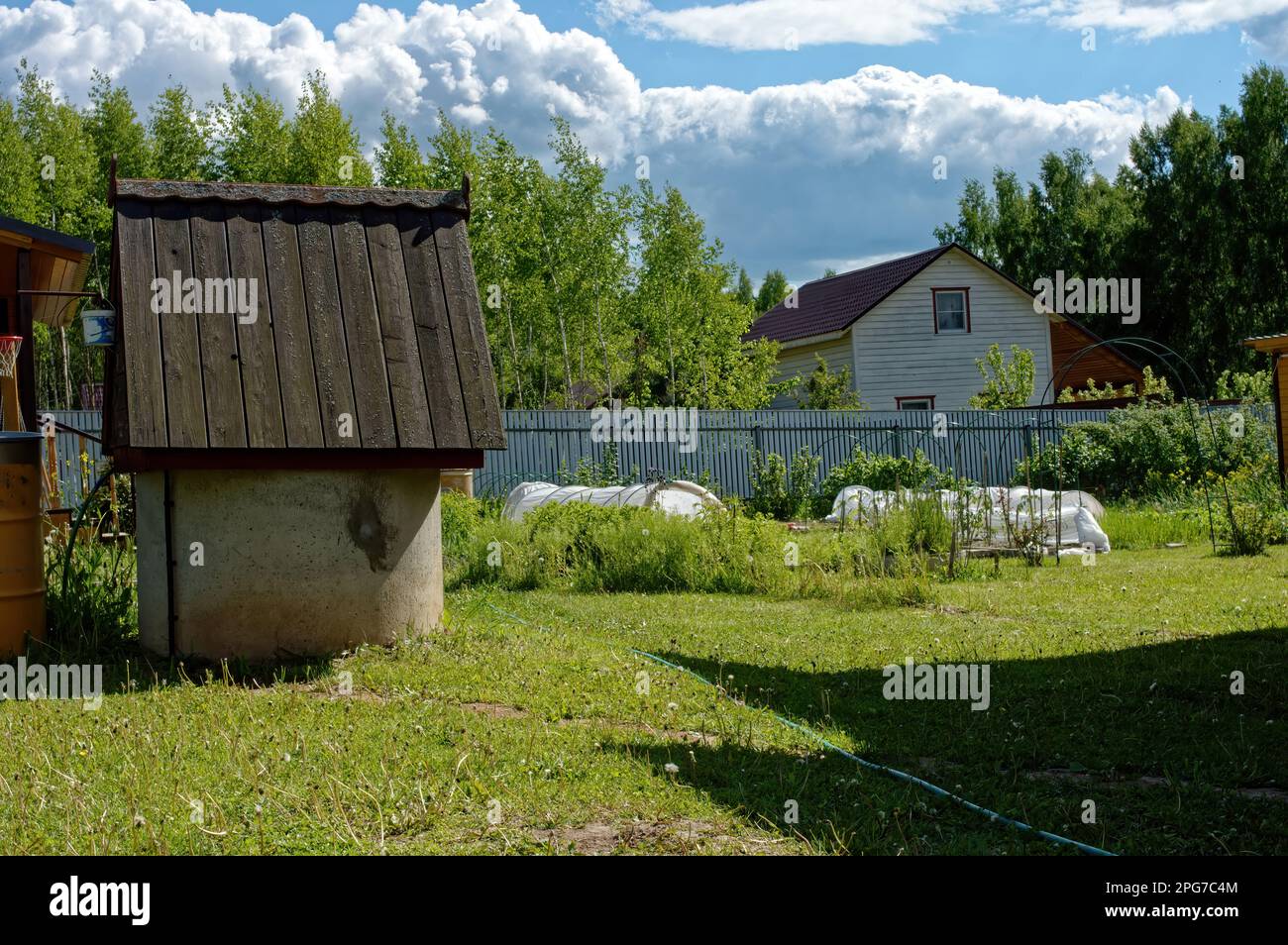plastic watering cans in the village, in the spring Stock Photo - Alamy