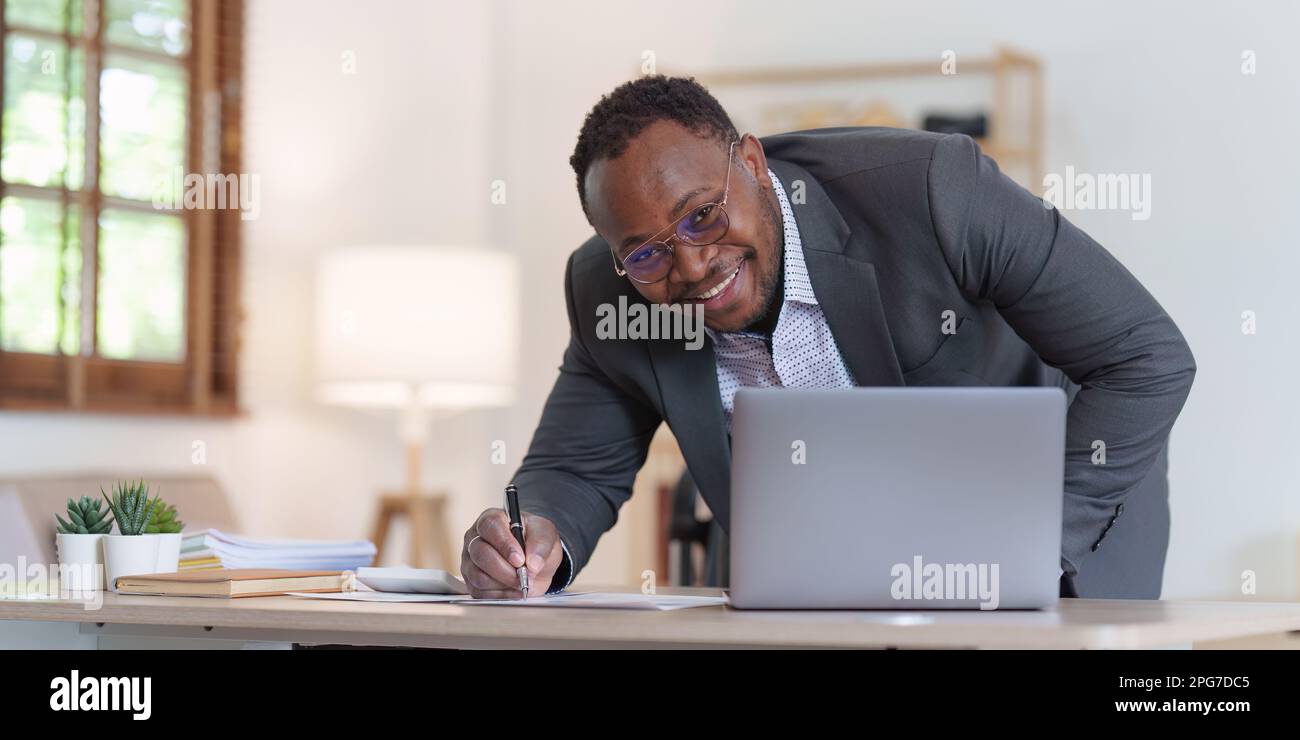 Smiling American African makes financial report and studies annual ...