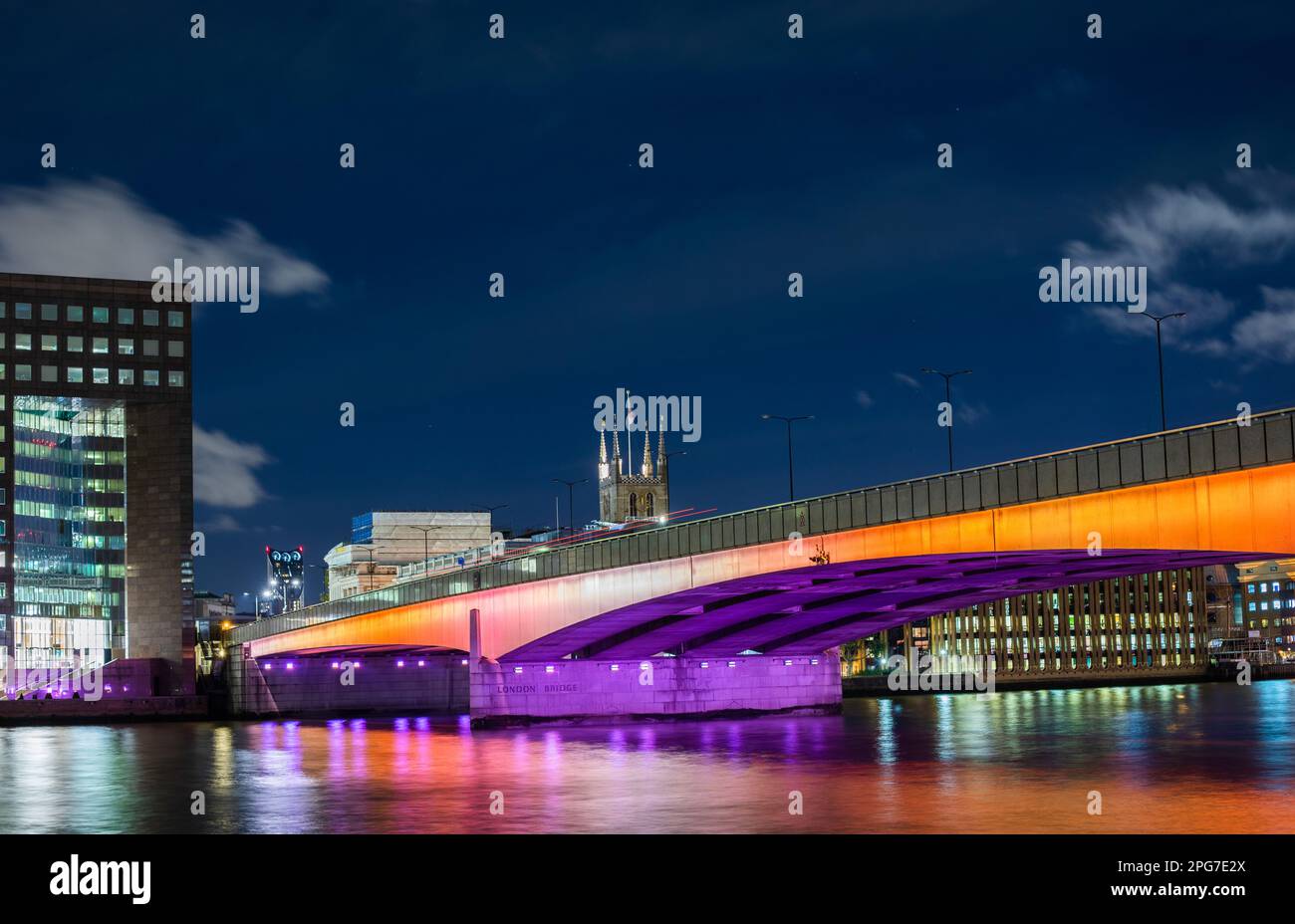 London Bridge lit in orange and purple as part of the Illuminated River ...