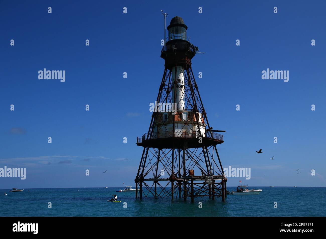 A view of a lighthouse standing tall in the water overlooking the vast ...