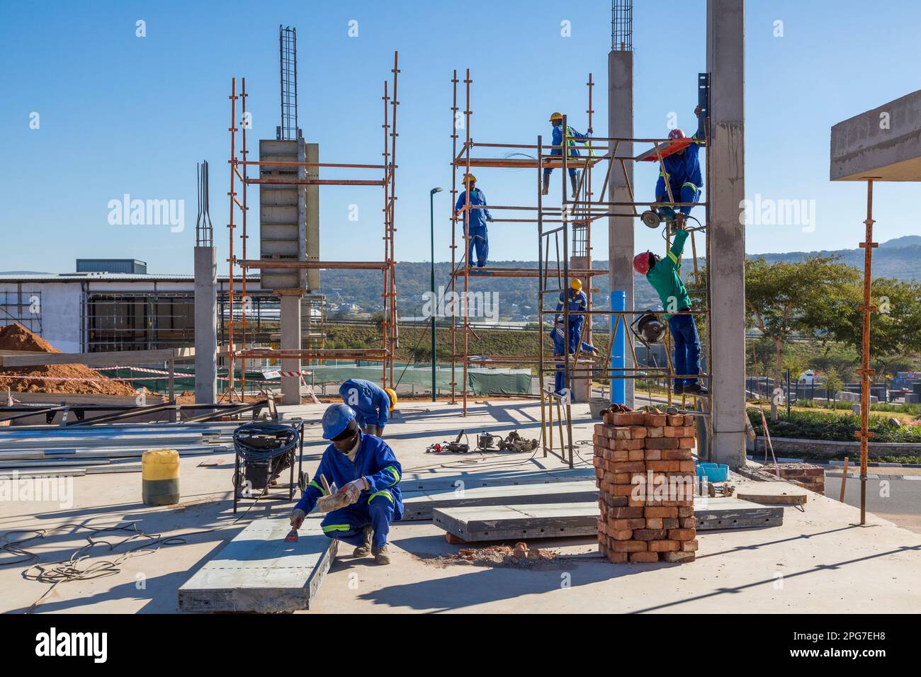 Construction workers busy with a variety of tasks on a commercial ...