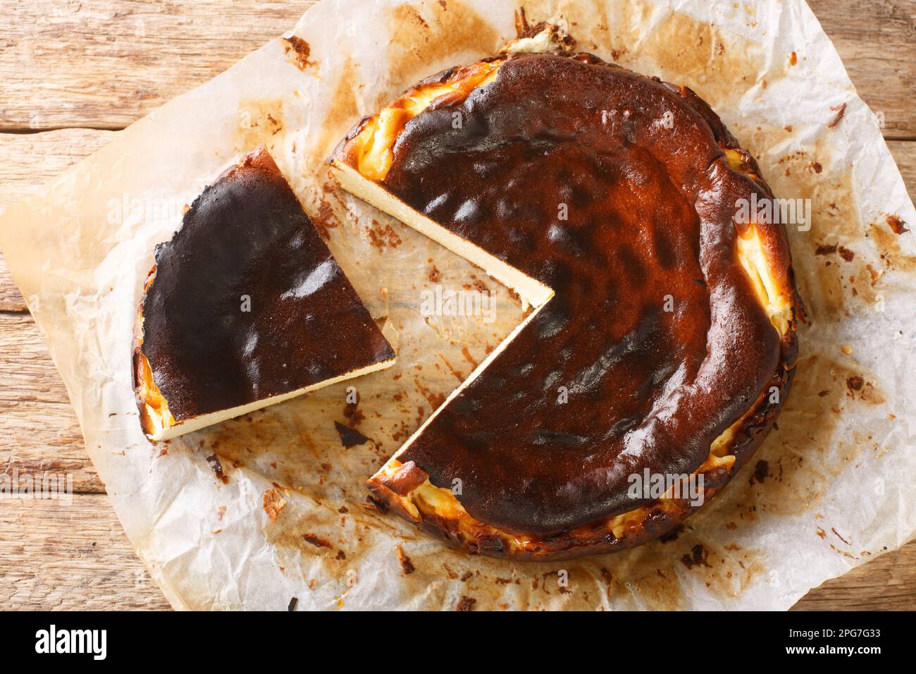 Traditional basque burnt cheesecake on a rustic wooden table closeup on ...