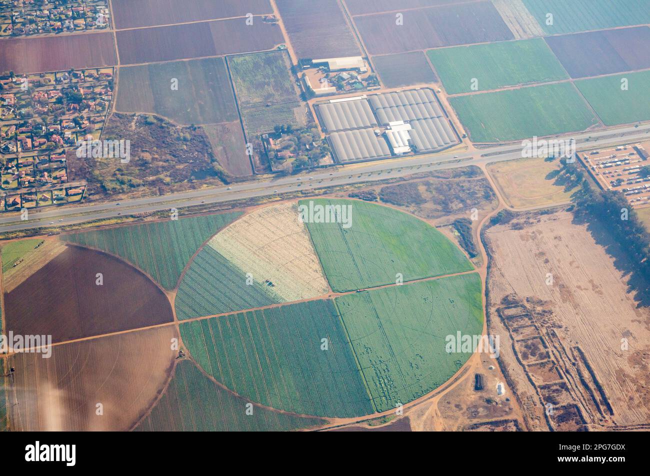 Aerial view of agricultural land adjoining a residential suburb in the ...