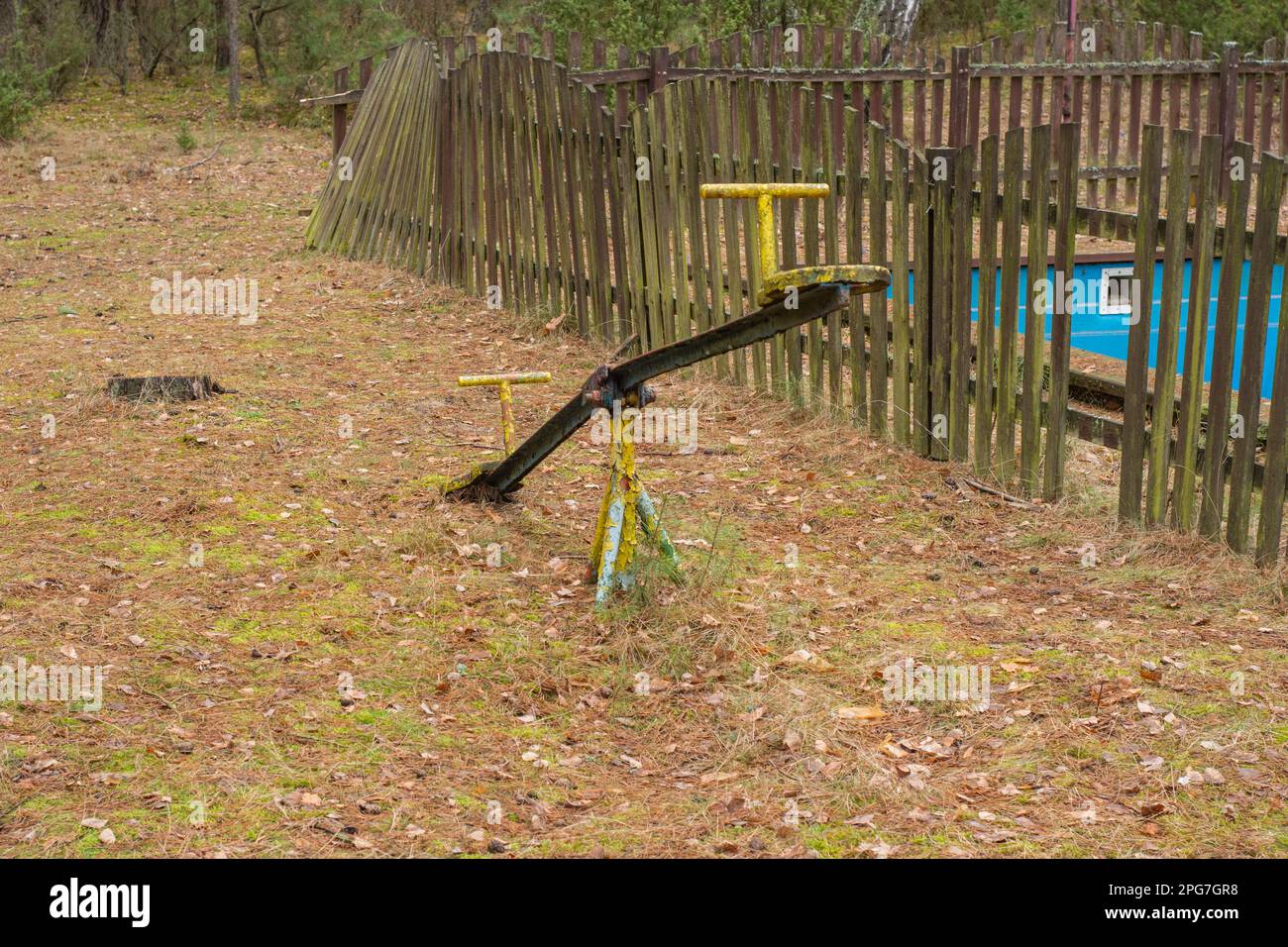 An old, dilapidated children's swing in an abandoned and forgotten ...