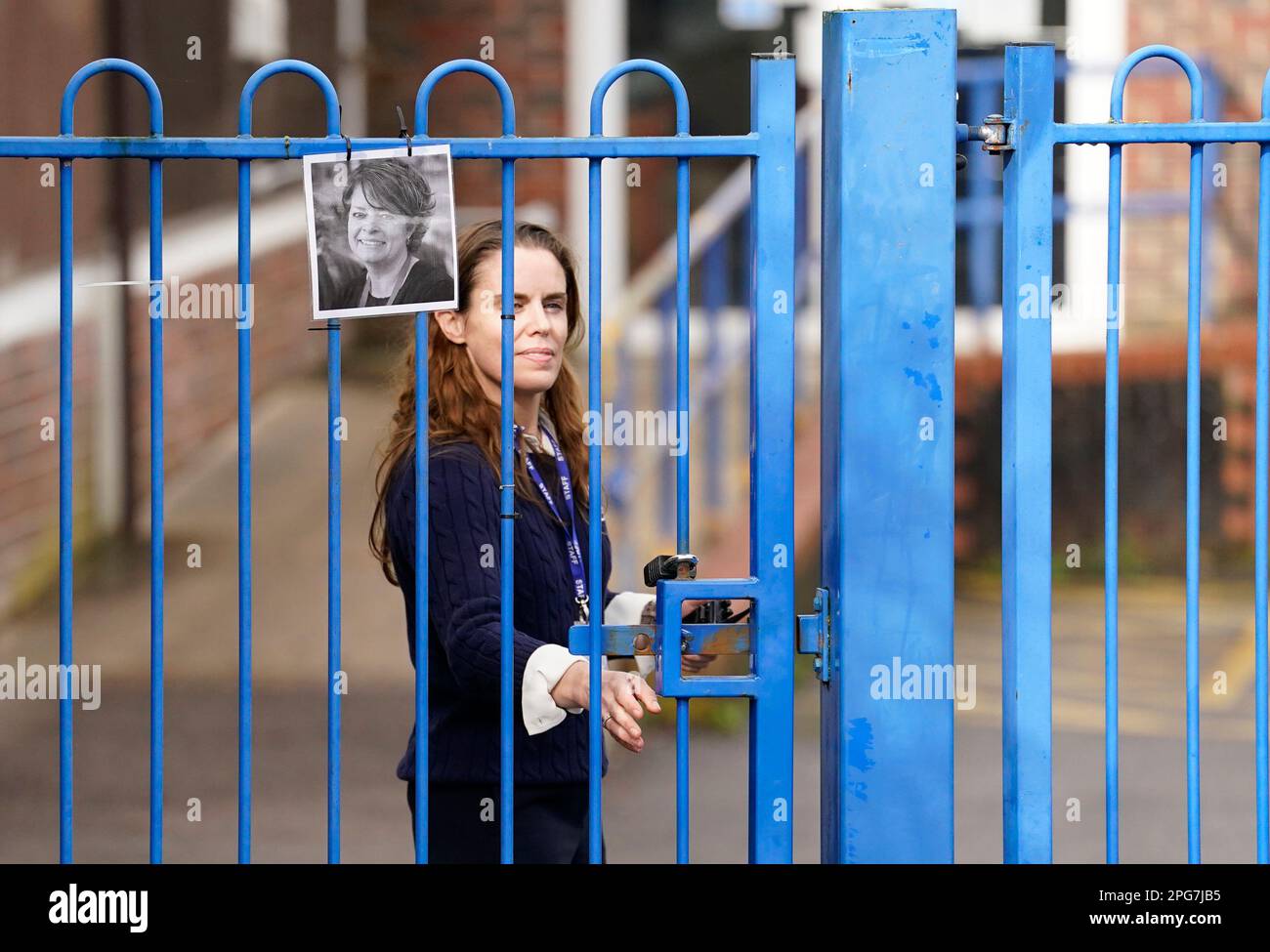 Headteacher Flora Cooper, wearing a black armband, stands next to a ...