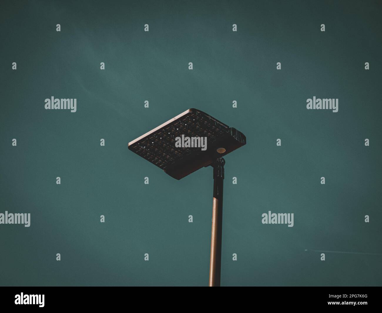An aerial view of a solitary street lamp against a backdrop of a clear ...