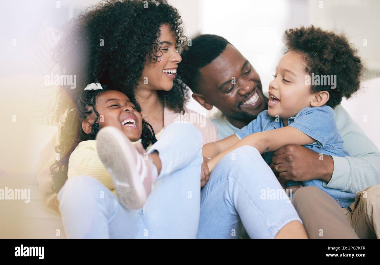 Happy family, laugh and relax on a sofa, bonding and playing in their ...