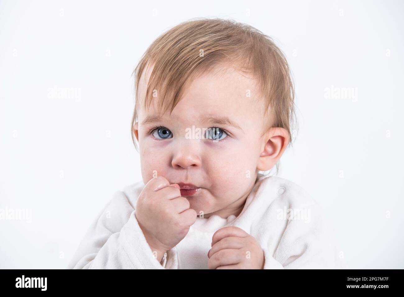 Stock studio photo with the white background of a baby's face with the ...