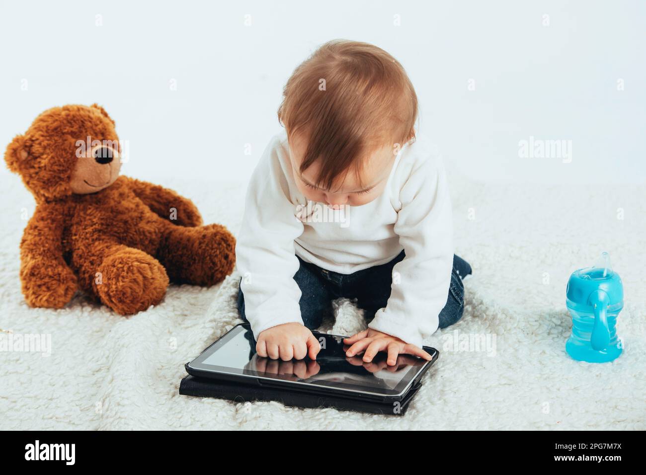 Stock studio photo with a white background of a baby looking at the ...