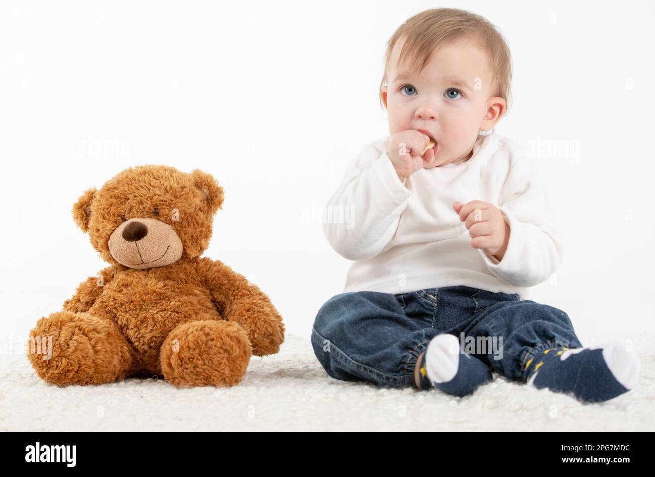 Stock studio photo with the white background of a baby with fingers in ...
