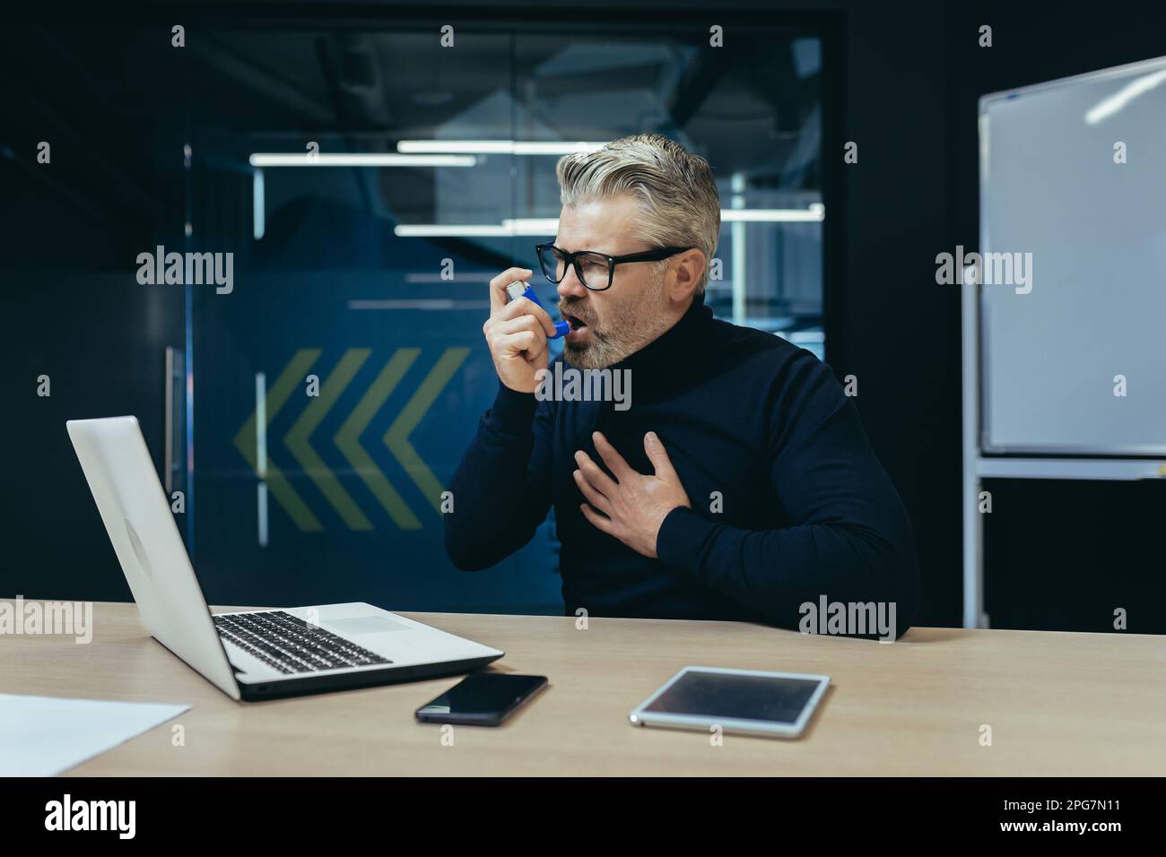 Senior gray-haired adult businessman sick at workplace inside office ...