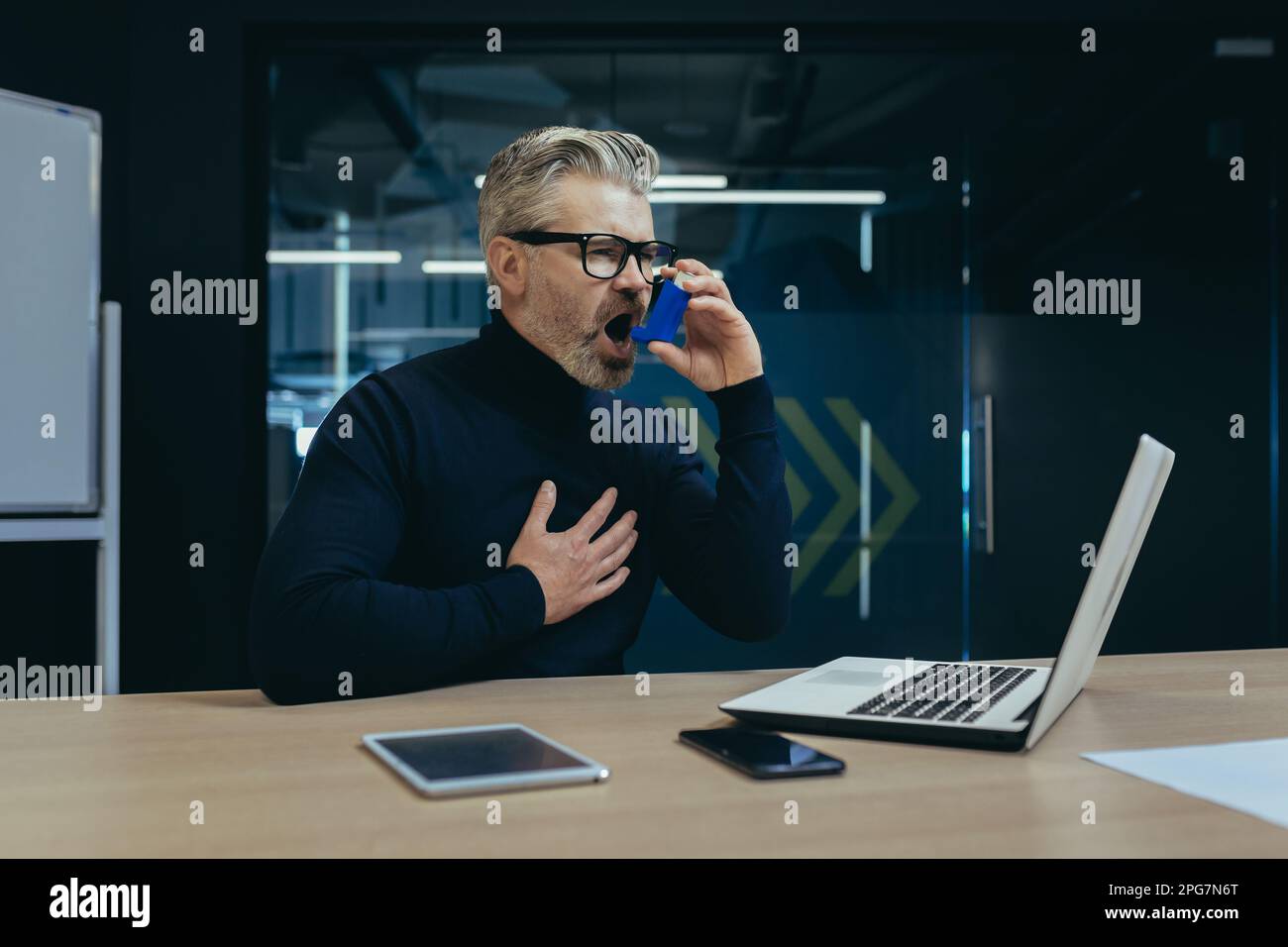 Senior gray-haired adult businessman sick at workplace inside office ...