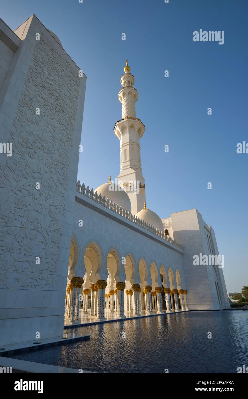 View of a tall minaret with reflecting pool, water feature. At the ...