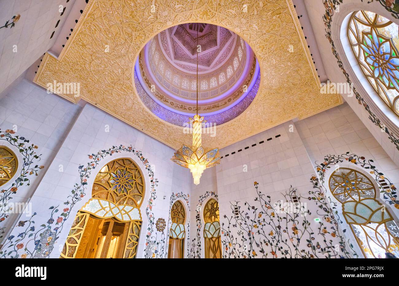 Detail view of interior of a blue dome with gold chandelier. At the ...