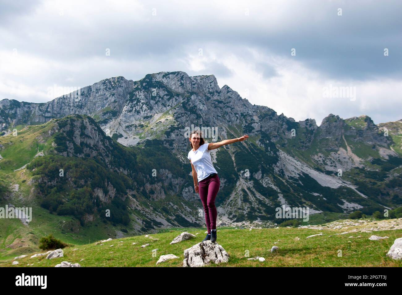 two long hair girls happy jump in mountains with exciting view of ...