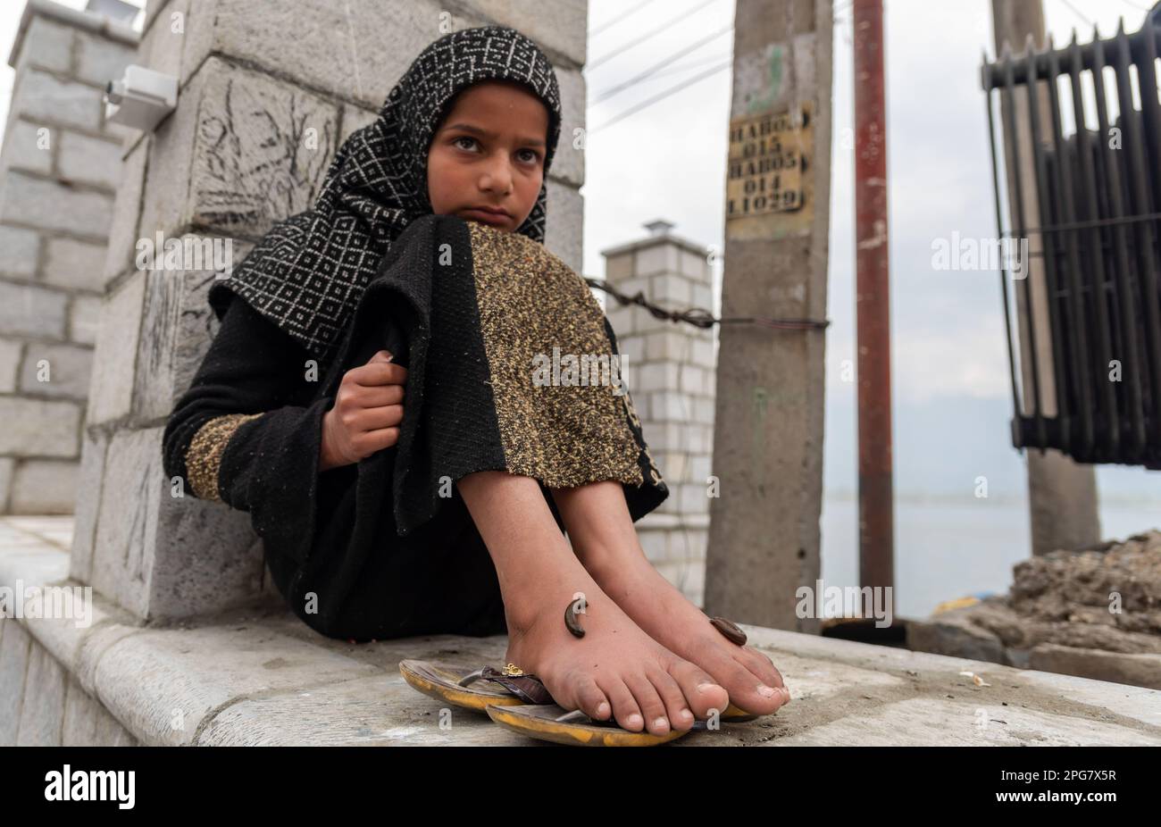 Srinagar, India. 21st Mar, 2023. A Kashmiri girl watches as she ...