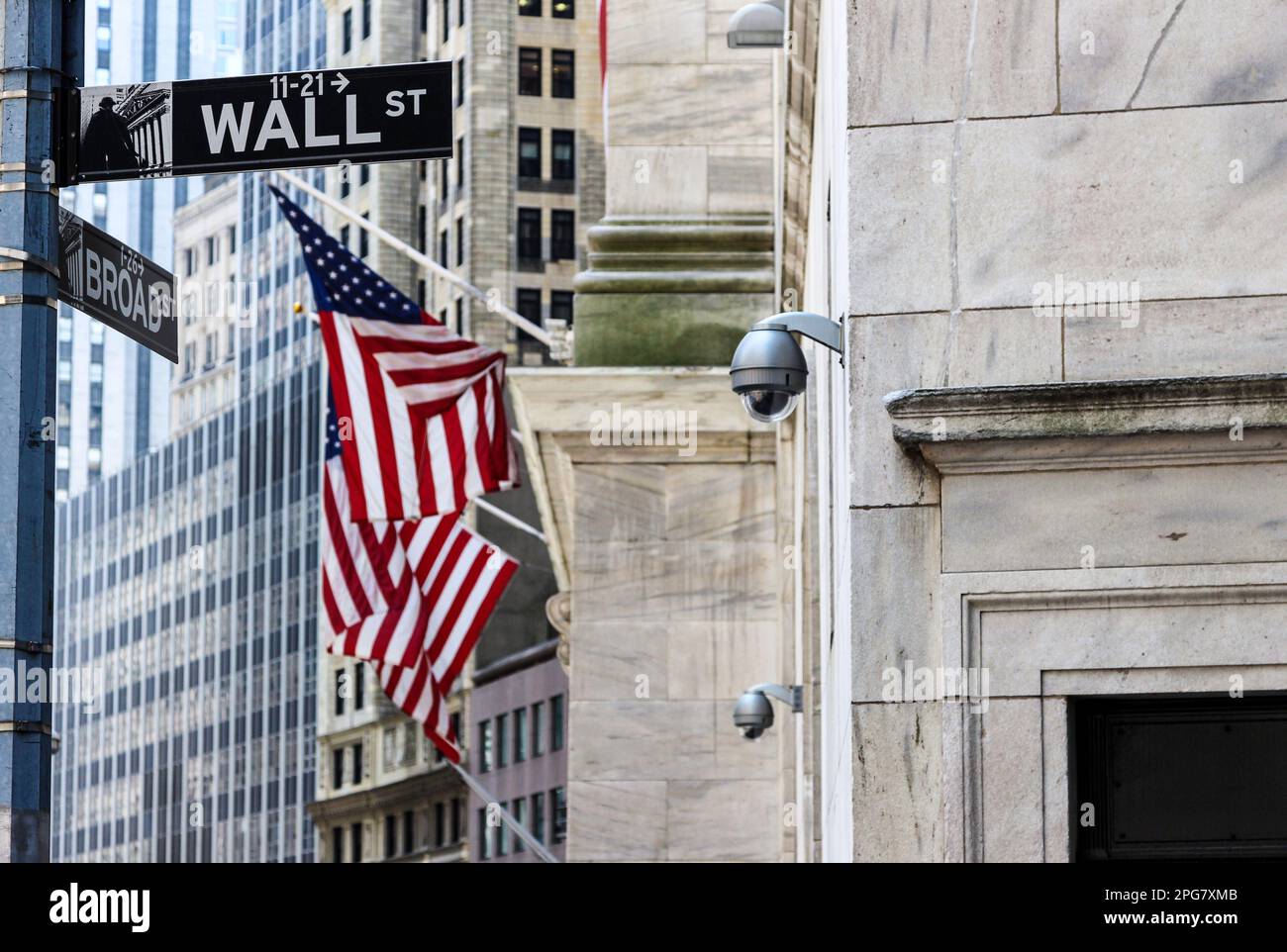 A line of American flags hanging near a Wall Street sign Stock Photo ...