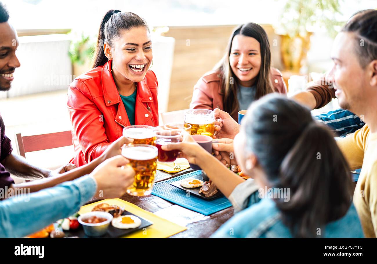 Trendy friends toasting beer and juices at business brunch venue - Food ...