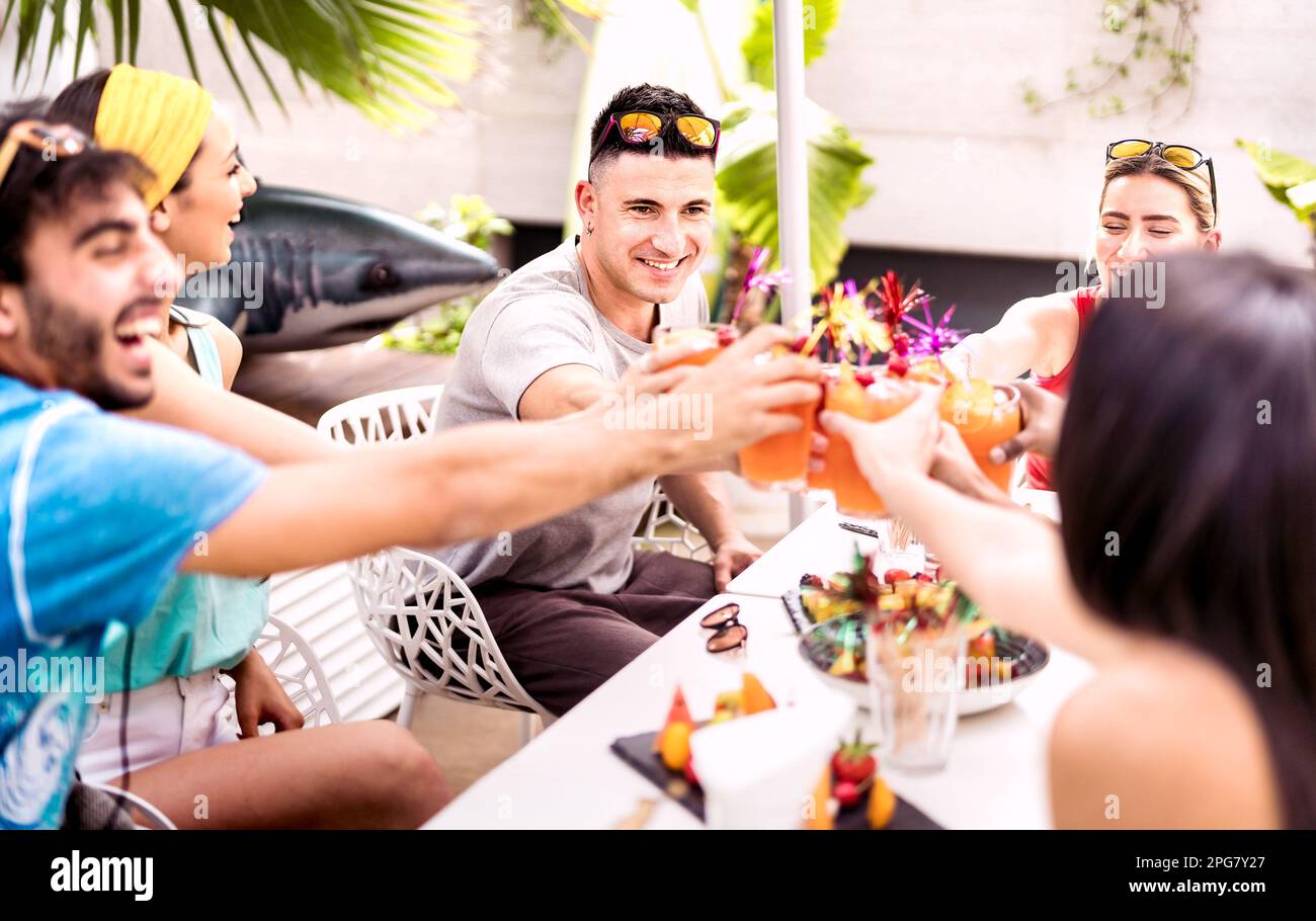 Fancy people drinking cocktails at poolside party - Young friends ...