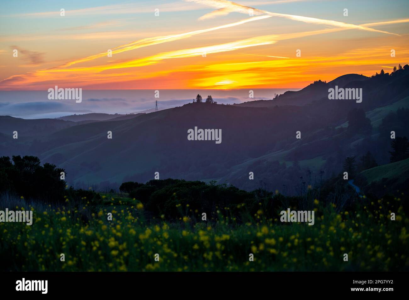A stunning sunset view of the rolling hills with clouds floating in the ...