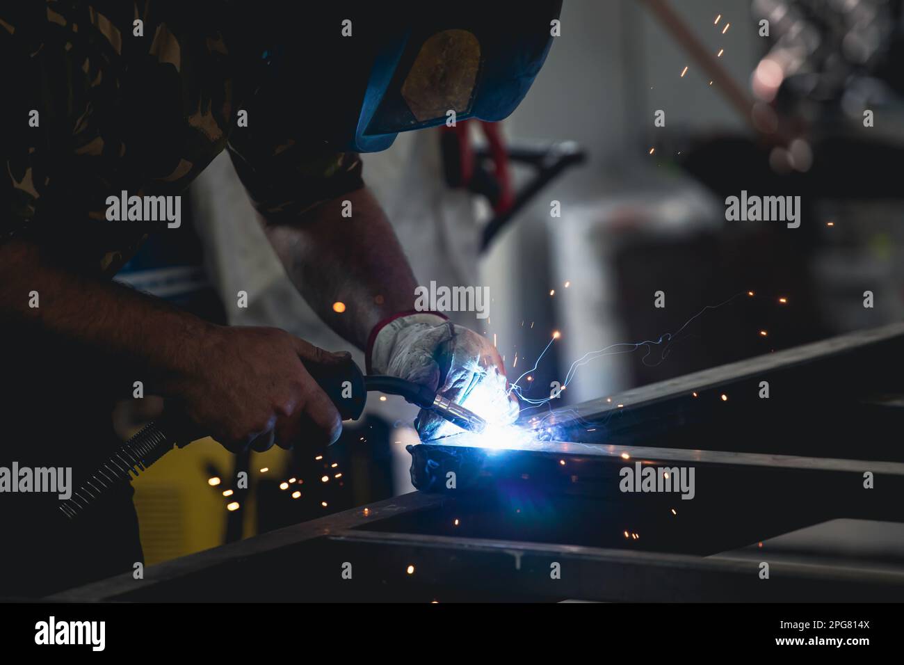 Handyman performing welding and grinding at his workplace in the ...