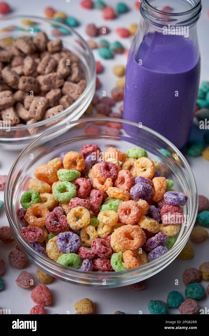 A vertical shot of a brightly colored assortment of breakfast cereals ...