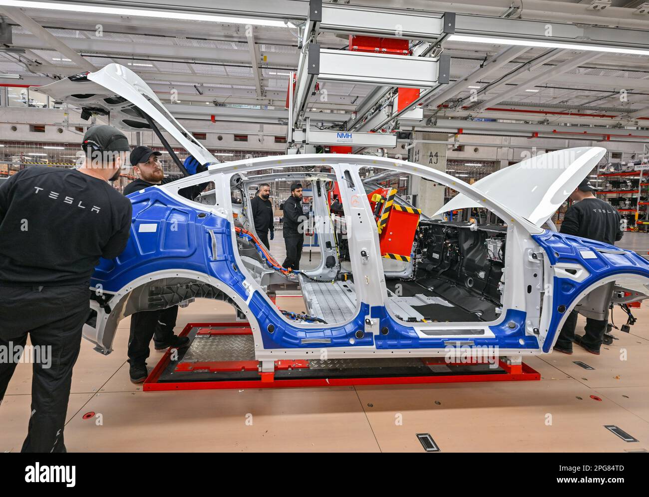 20 March 2023, Brandenburg, Grünheide: Employees of the Tesla ...