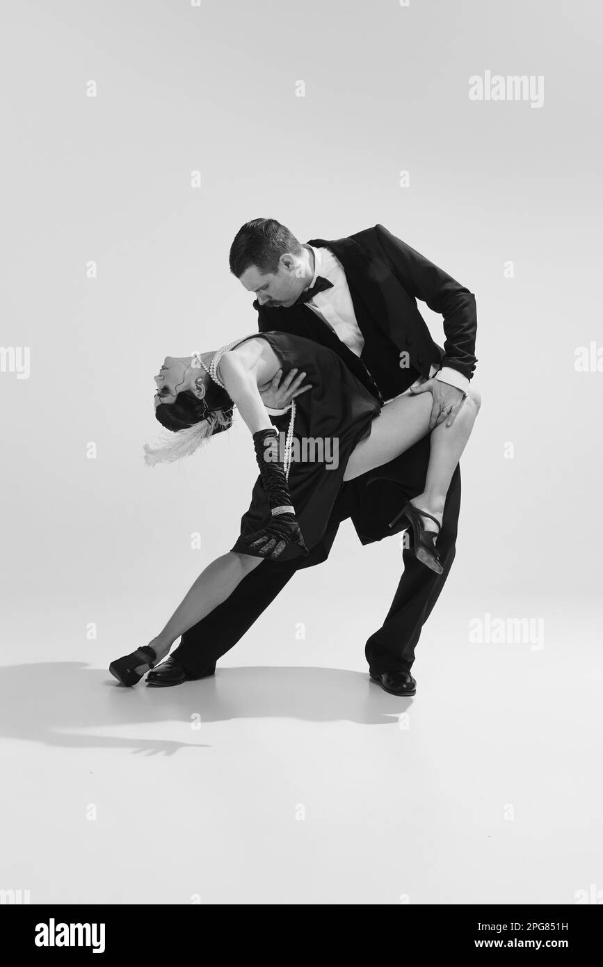 Portrait of stunning couple wearing vintage style clothes and dancing ...