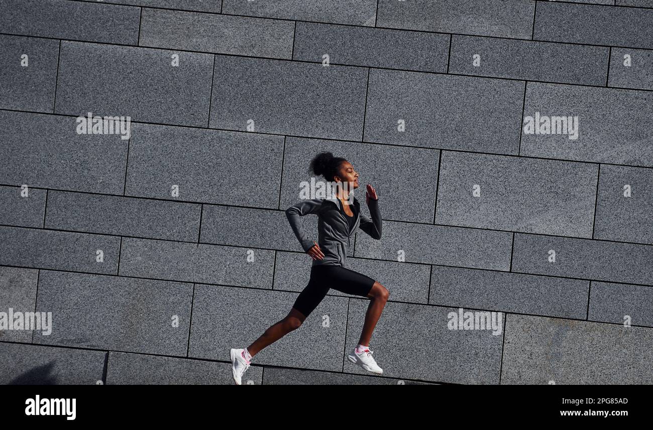 Active runner. Young african american woman in sportive clothes have ...