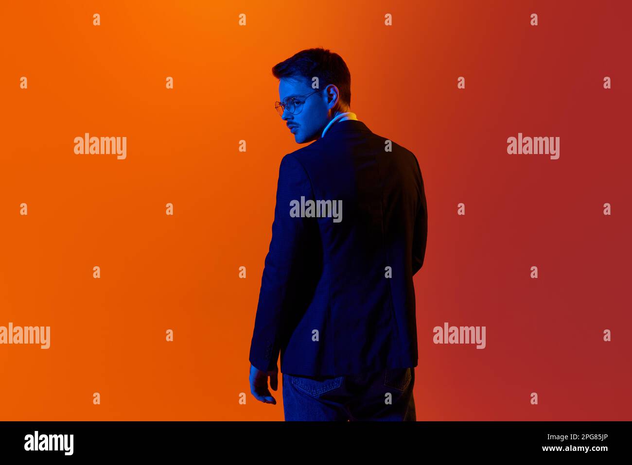 Side view portrait of young man in jacket posing with serious face ...