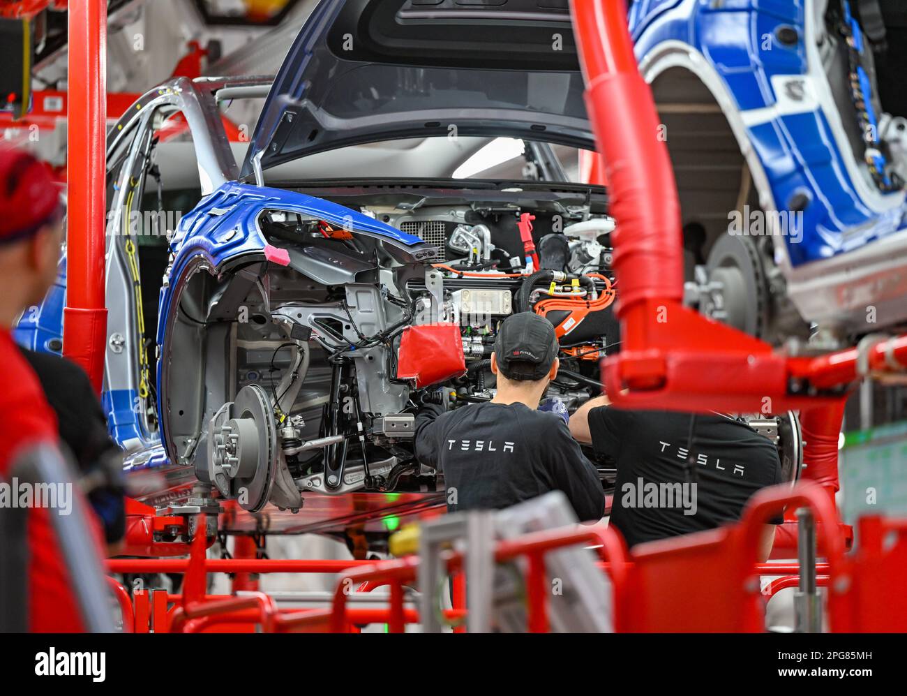 20 March 2023, Brandenburg, Grünheide: Employees of the Tesla ...