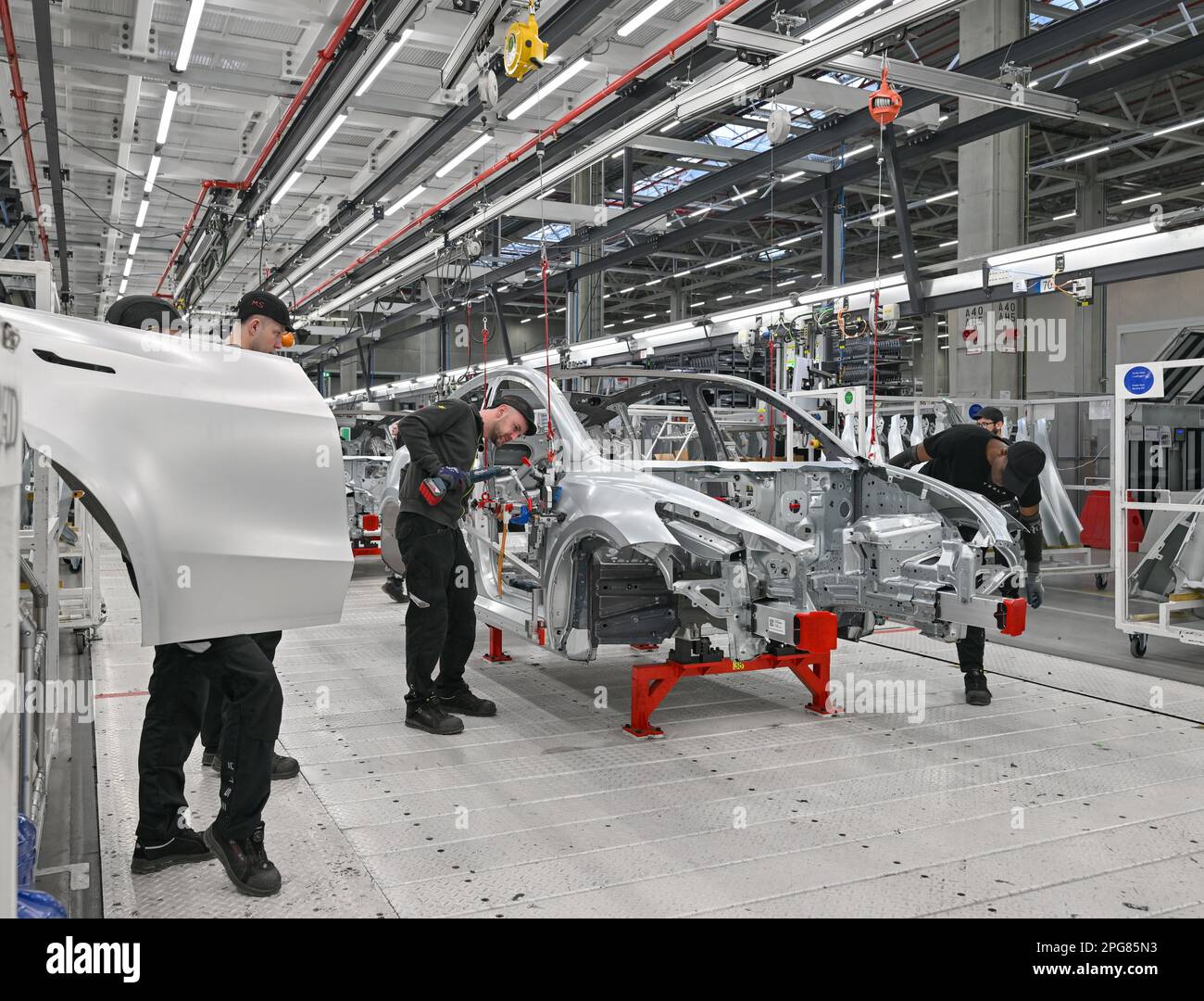 20 March 2023, Brandenburg, Grünheide: Employees of the Tesla ...
