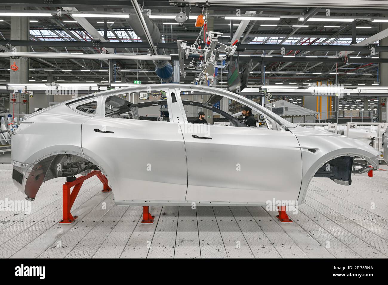 20 March 2023, Brandenburg, Grünheide: Employees of the Tesla ...