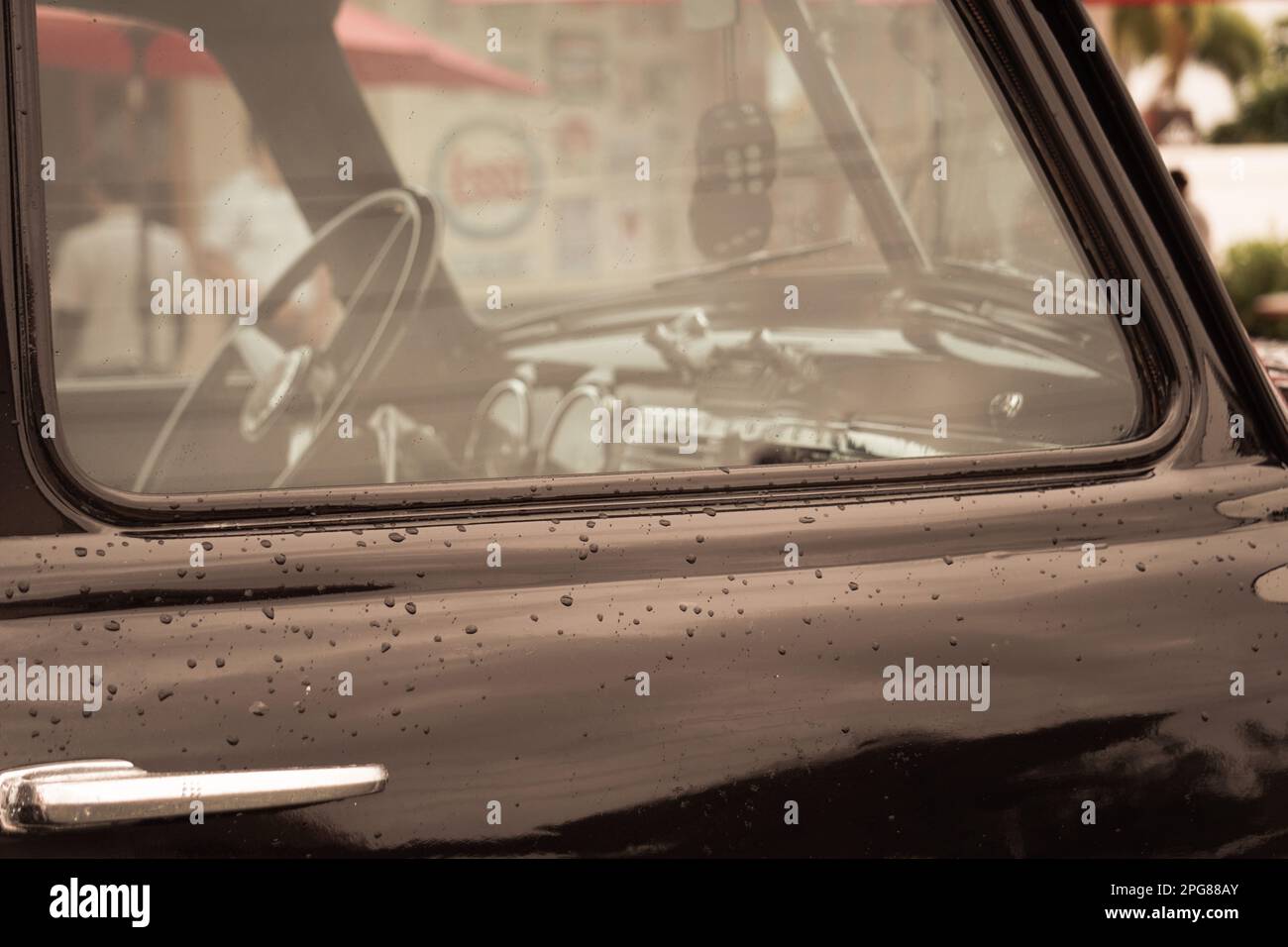 An antique pickup truck with a classic steering wheel visible in the ...
