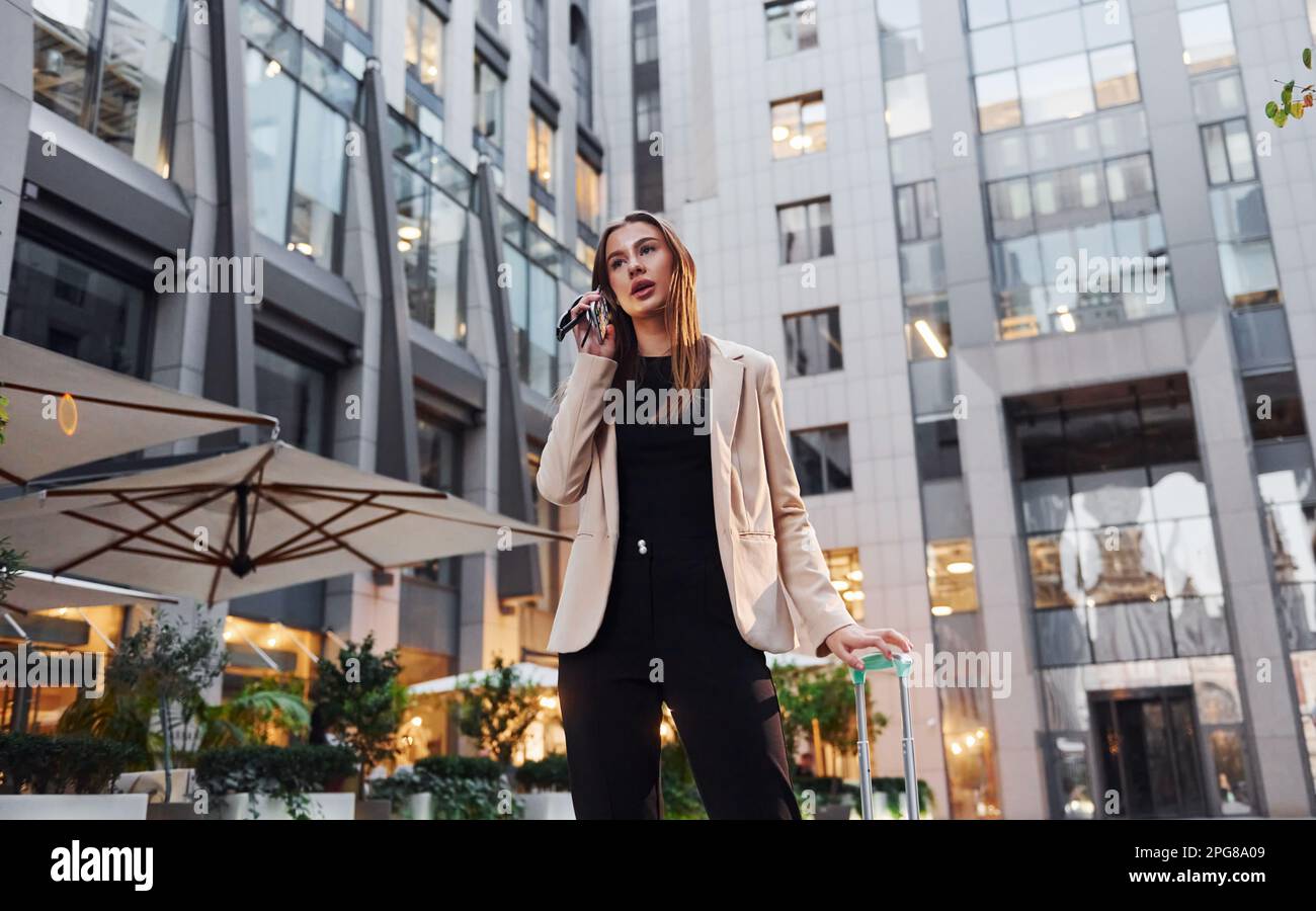 Town style clothes. Beautiful young european woman is outdoors in the ...