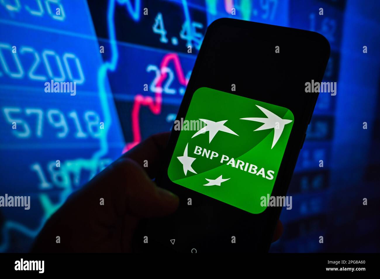 In this photo illustration, a BNP Paribas bank logo is displayed on a smartphone with stock ...
