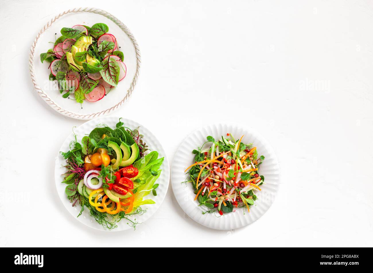 Various healthy salads of fresh vegetables,fruits and microgreens on ...