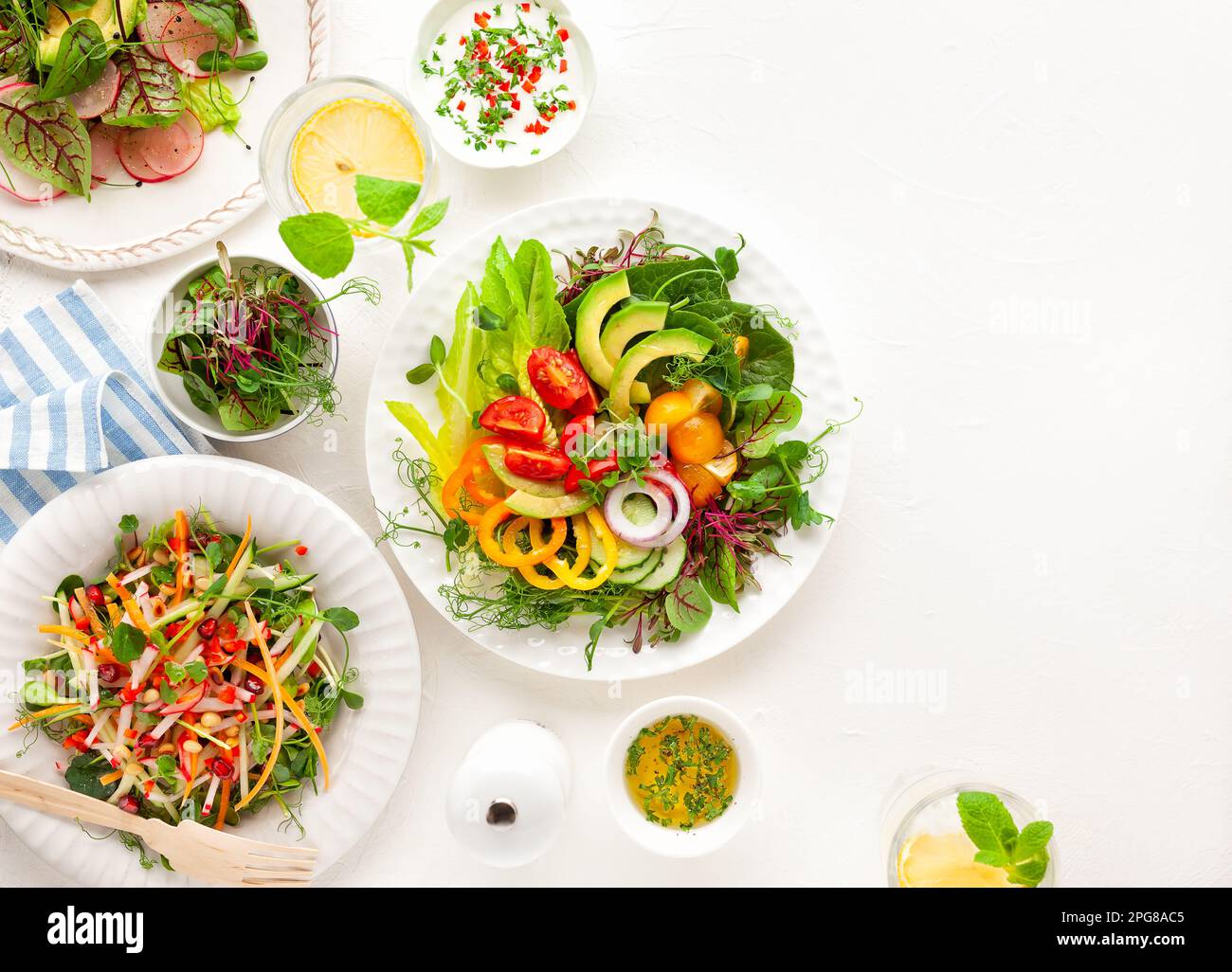 Various healthy salads of fresh vegetables,fruits and microgreens on ...