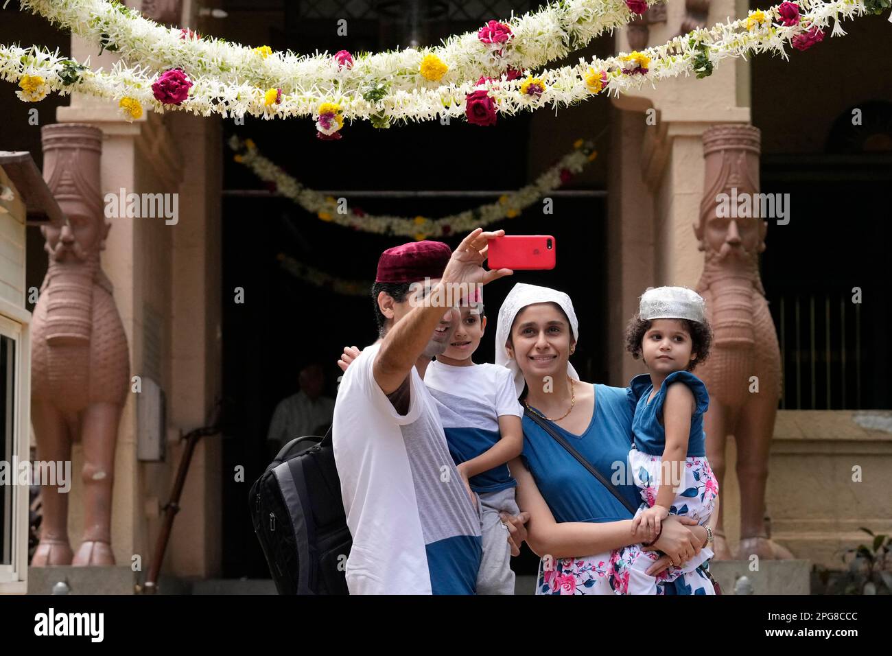 A Parsi family takes a selfie outside a fire temple after offering ...
