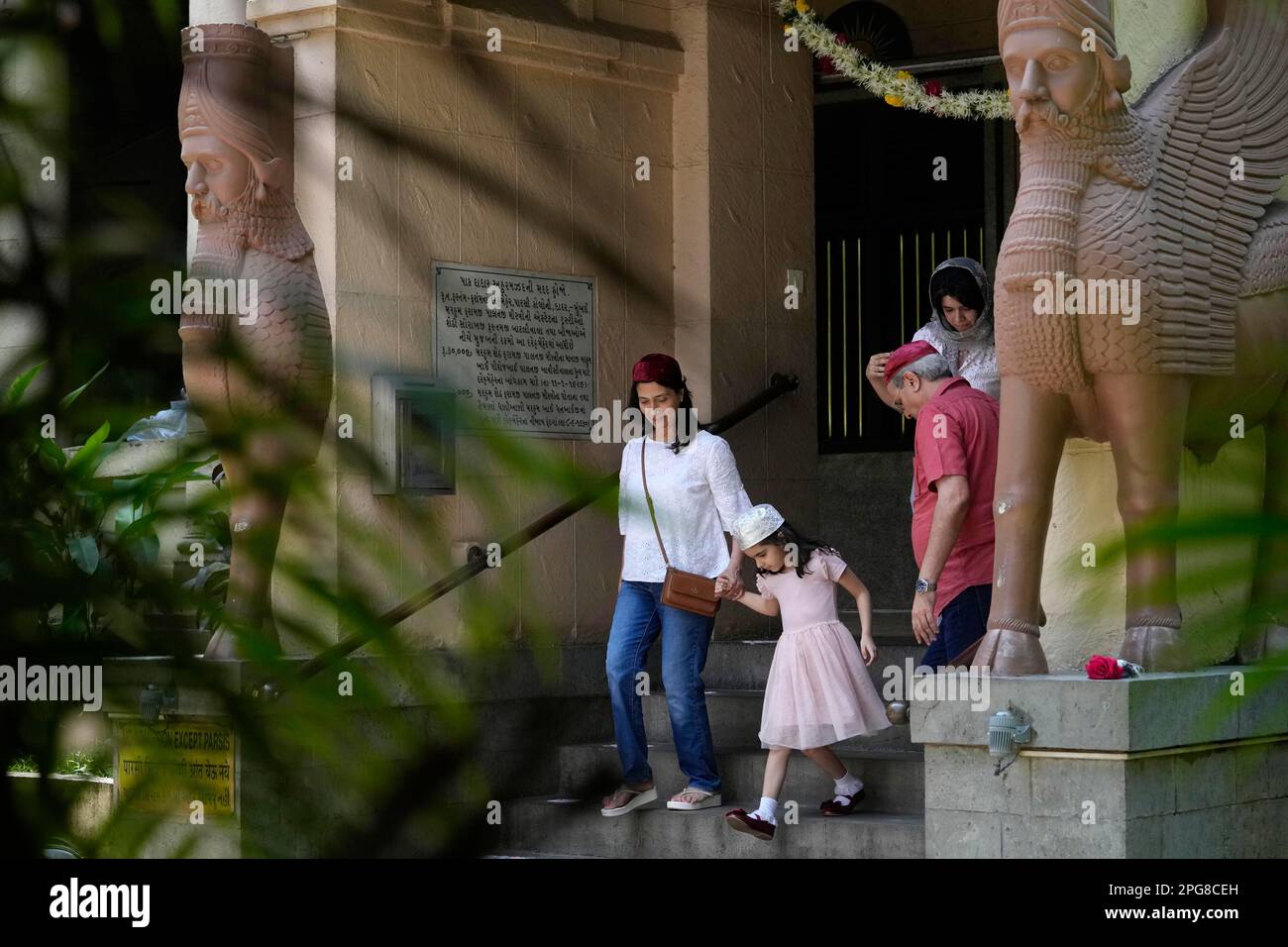 A Parsi family leaves a fire temple after offering prayers on Navroz ...