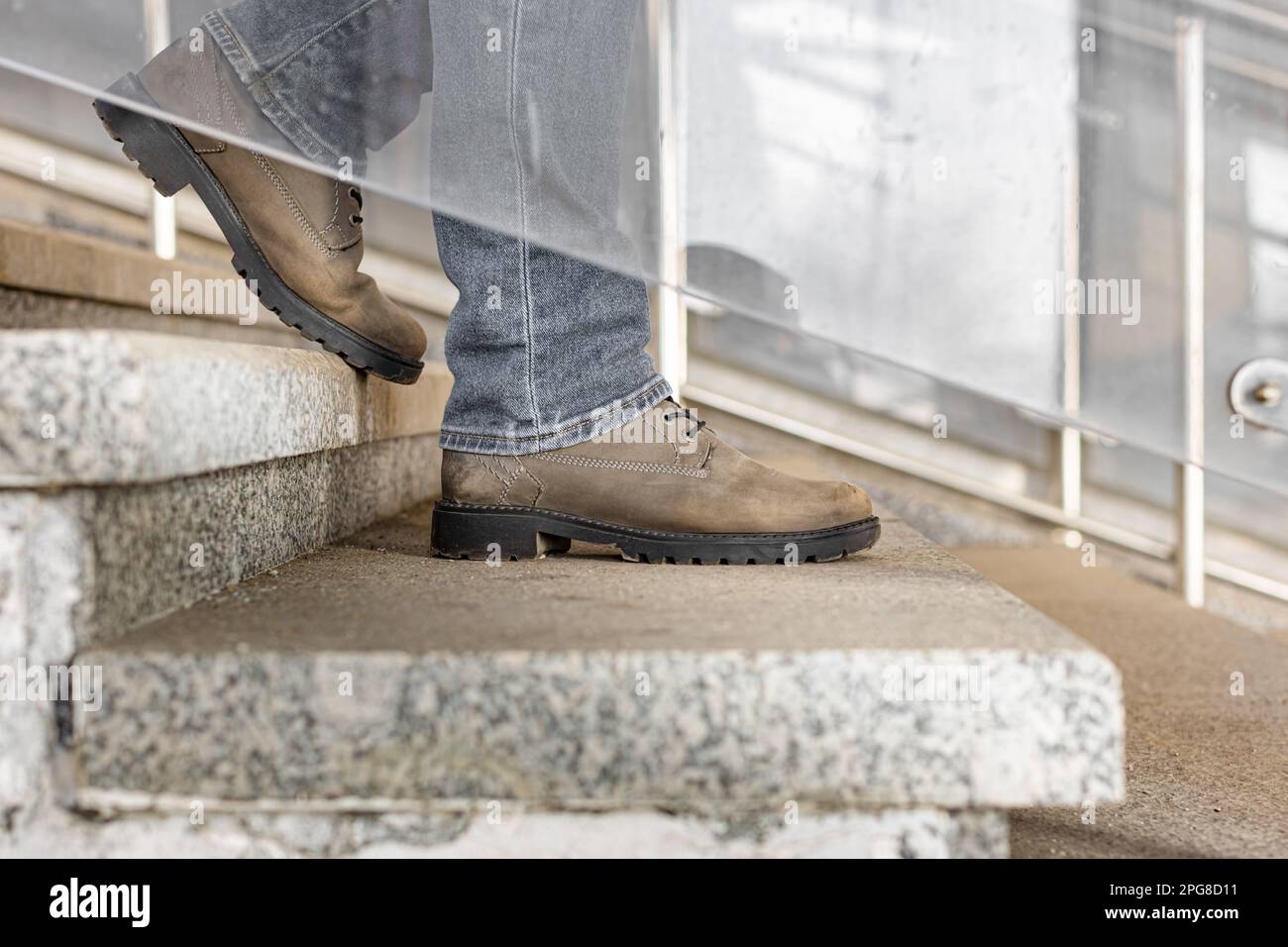 a man descends the steps in the passage. foot on the steps Stock Photo ...