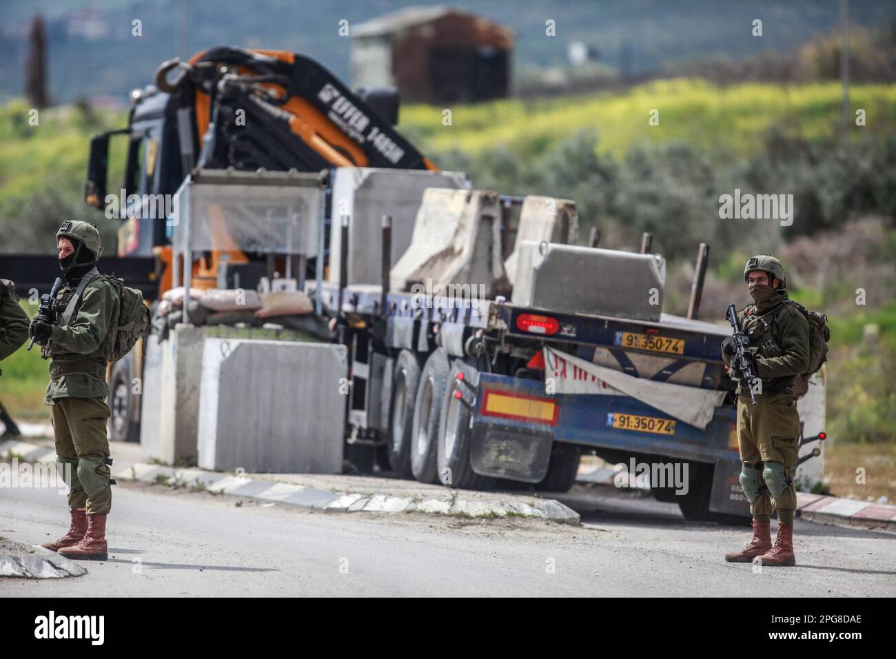 Nablus, Palestine. 21st Mar, 2023. Israeli army forces set up a new military checkpoint in the ...
