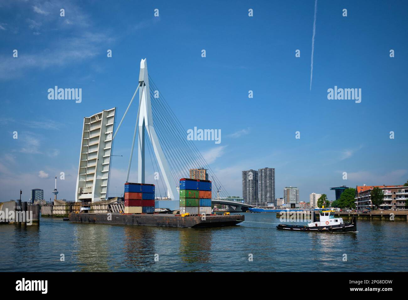 Tug boat towing barge with containers under open bascule part of ...