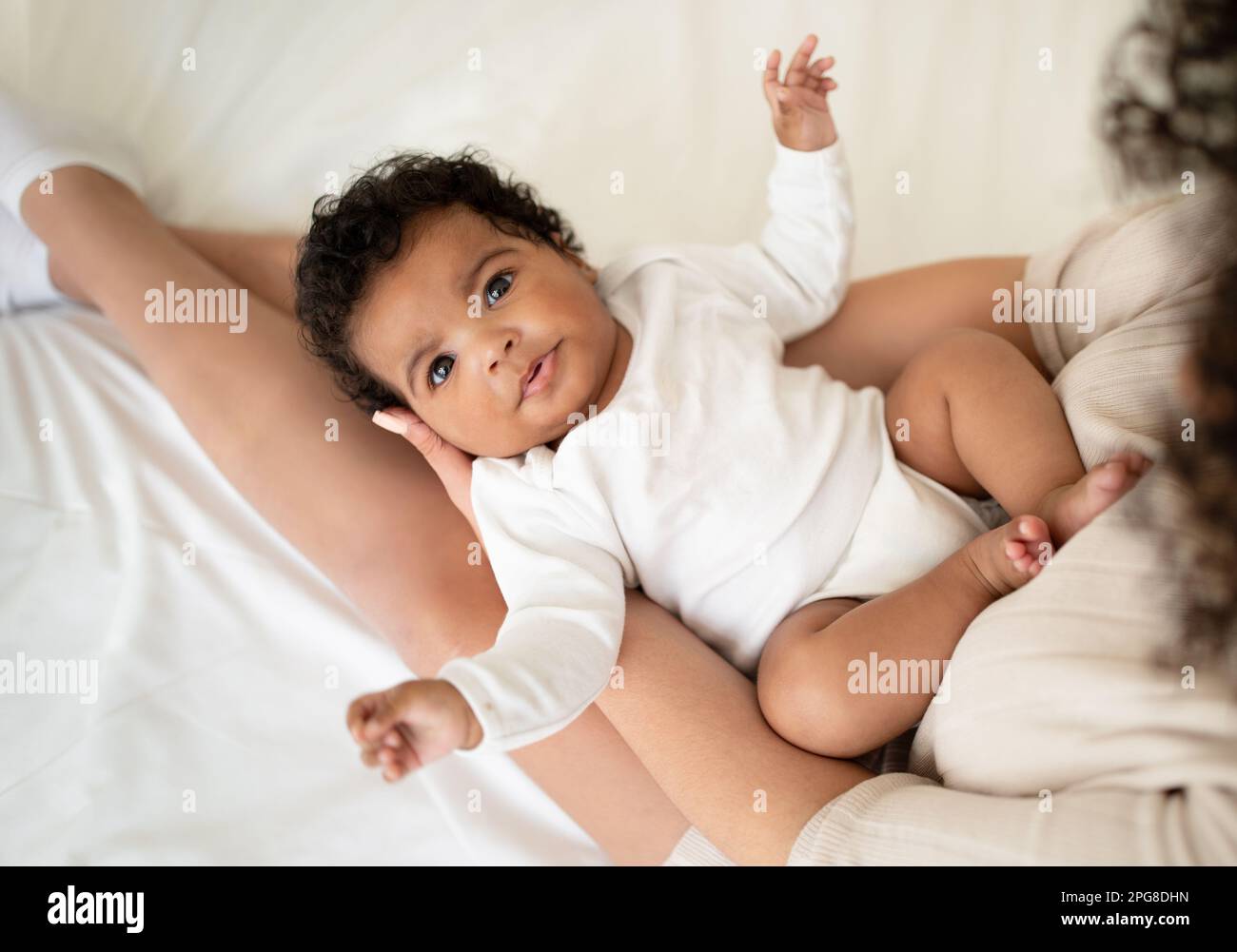 Loving young african american lady holding cute baby in her arms, enjoy ...