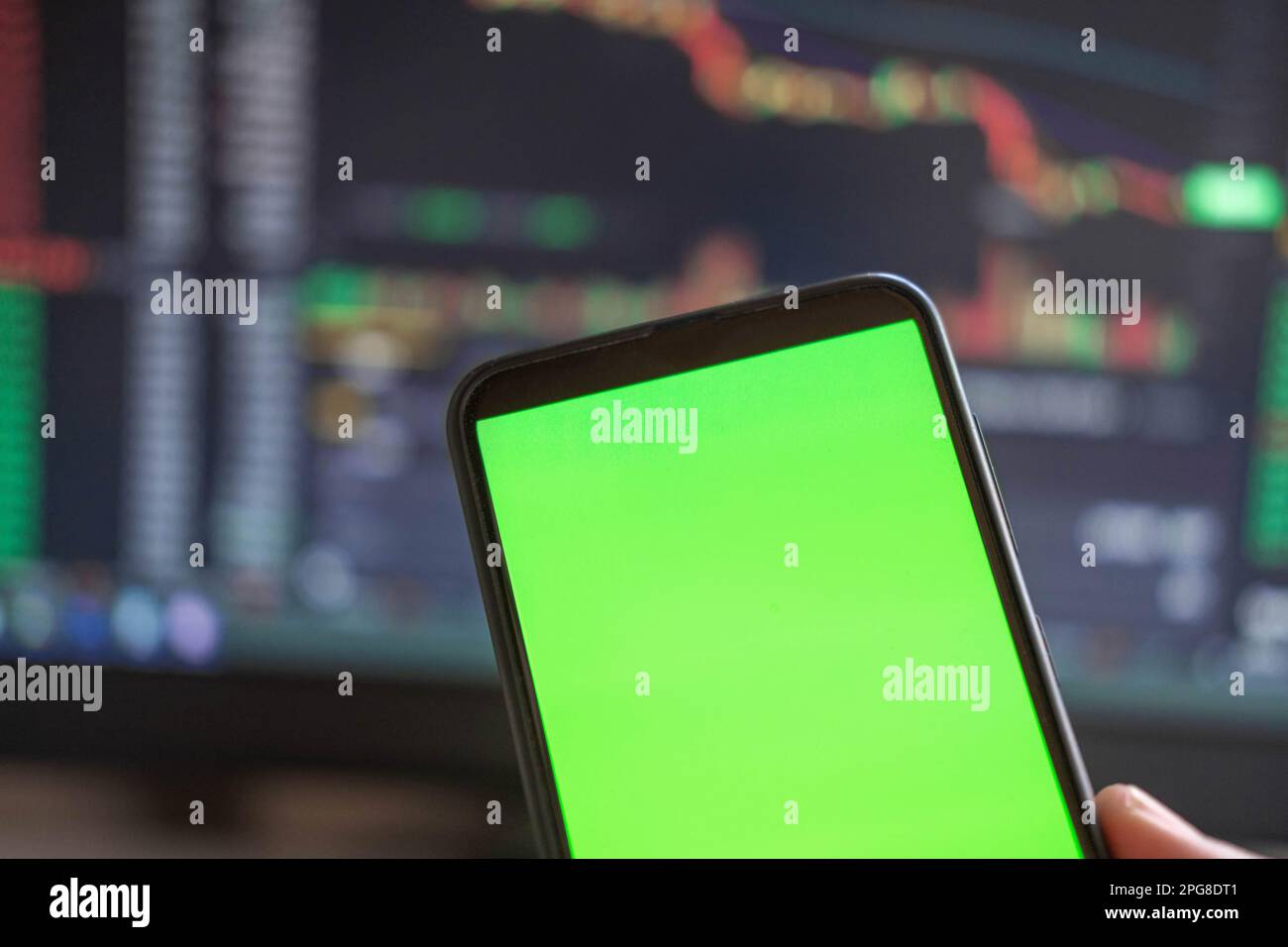 Black phone with blank mockup screen on rising stock graph. Closeup ...