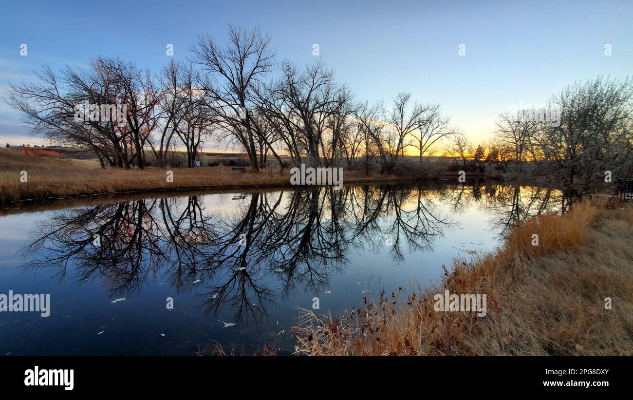 An idyllic nature scene featuring a tranquil body of water surrounded ...