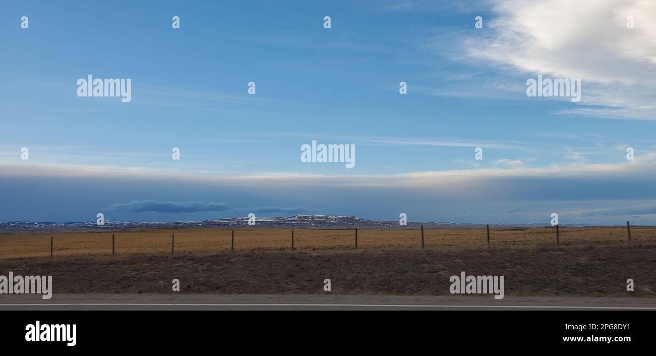 A wide-angle shot of a rural landscape featuring a vast expanse of ...