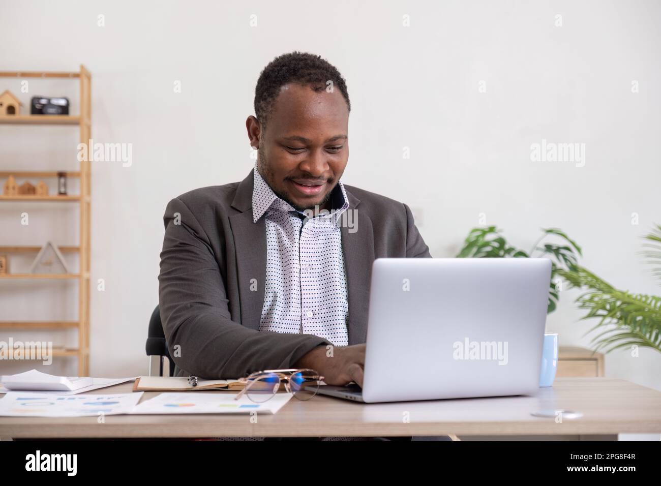 Accountant black man working on laptop and do document, tax, exchange ...